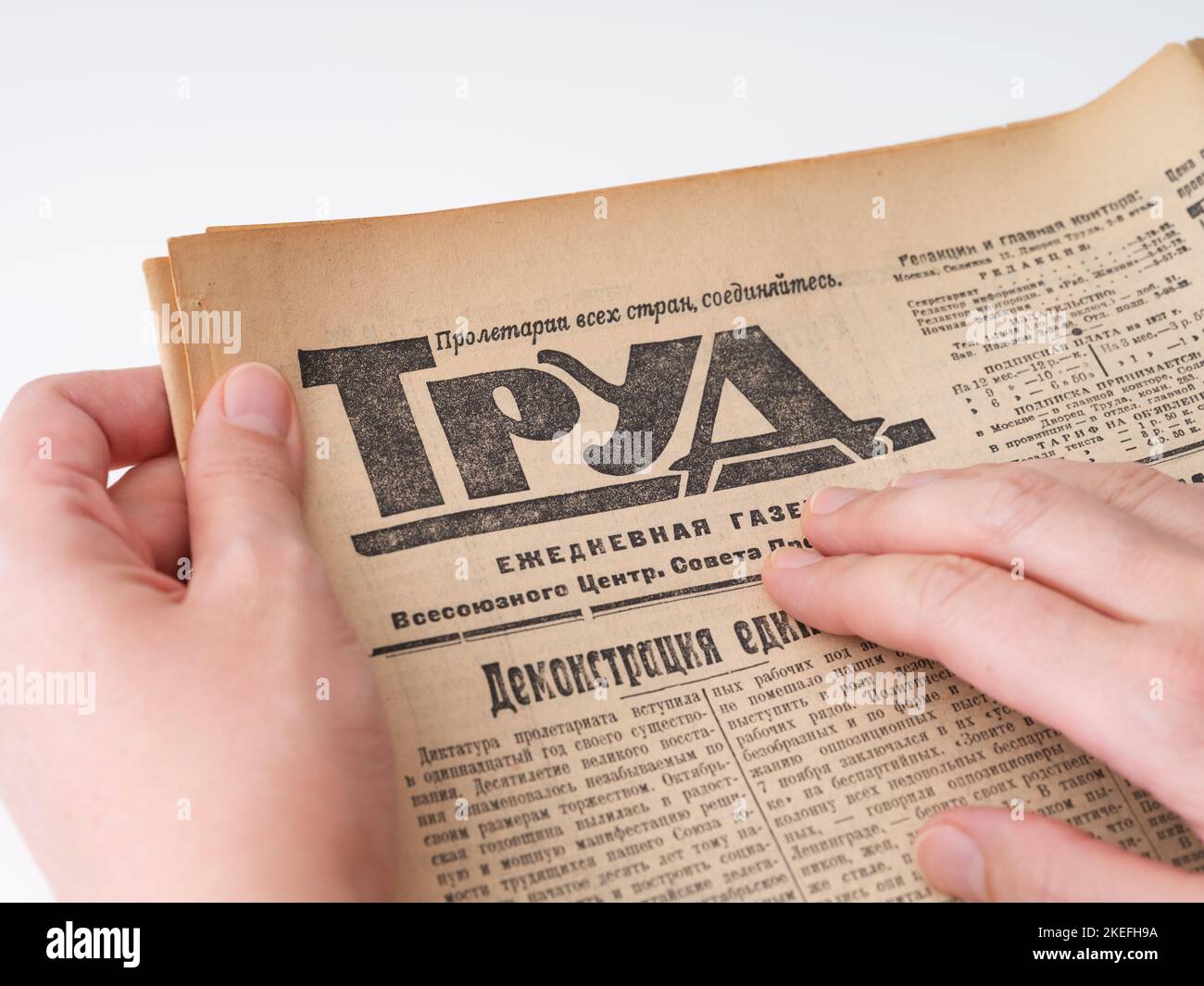 An old soviet newspaper Trud (Labor) in a woman hands. The newspaper ...