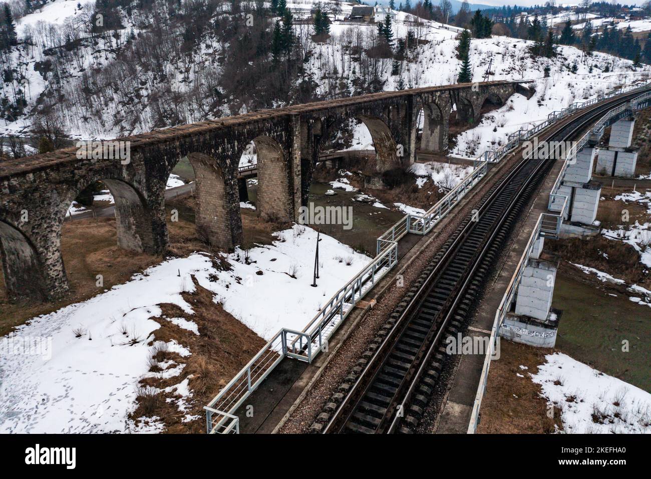 Old viaduct bridge and new bridge over a mountain river in a mountain ...