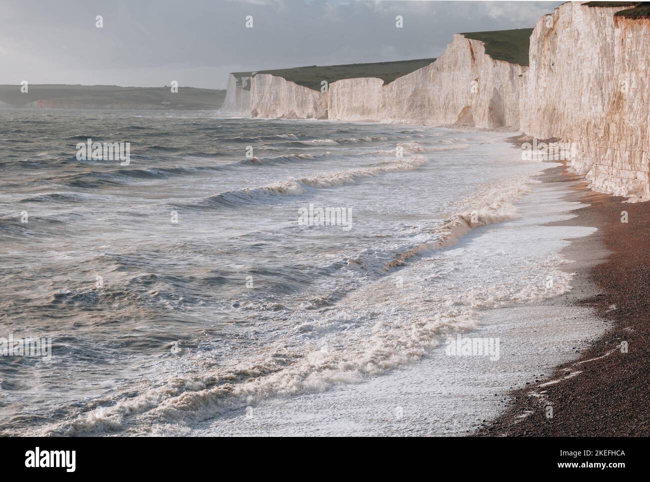 Waves hitting the beach by Seven Sisters chalk cliffs, one of the ...