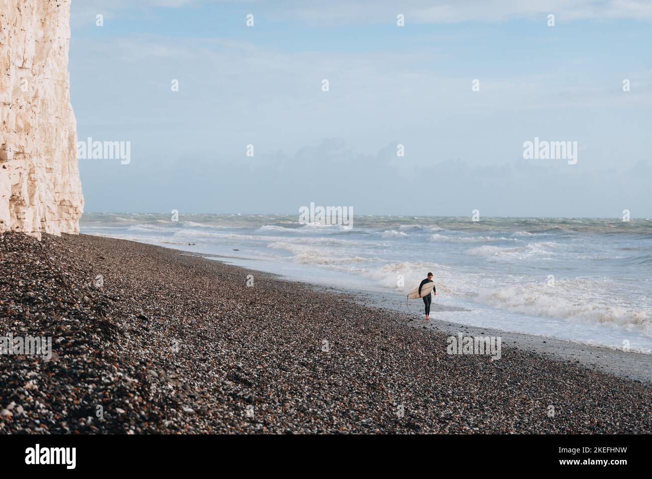 Seven Sisters, UK - October 1, 2022: Surfer with a board walking on the ...