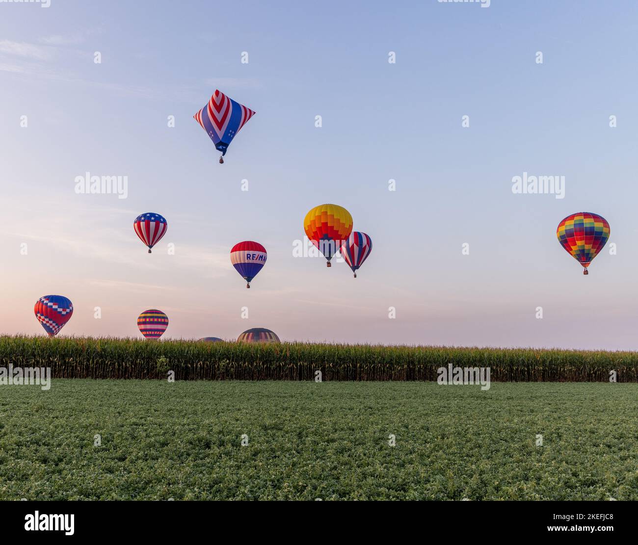 A scenic view of several hot air ballons floating in the sky during ...