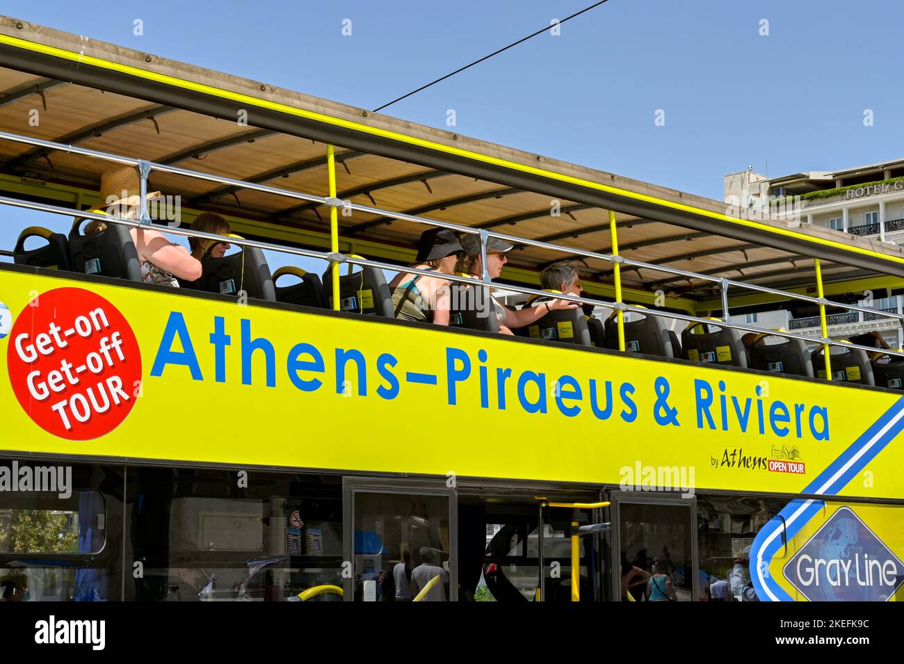 Athens, Greece - May 2022: Side view of people sitting on a hop on hop ...