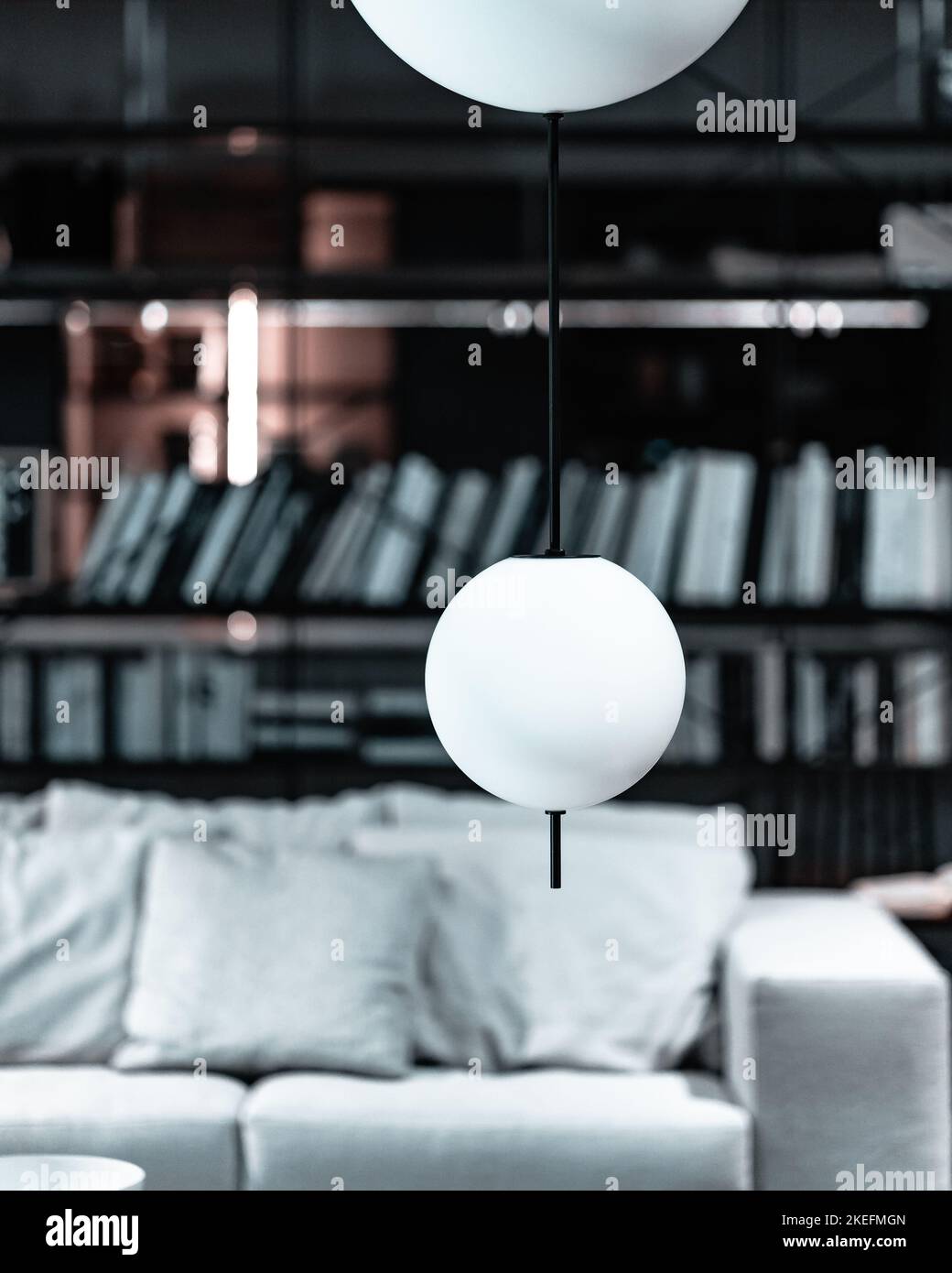 A vertical shot of a hanging modern round light in a living room Stock ...