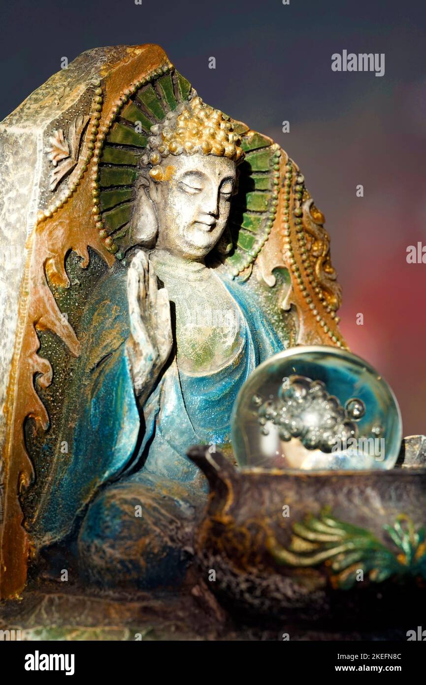 Meditating Buddha Statuette with Cauldron and Glass Ball Stock Photo ...