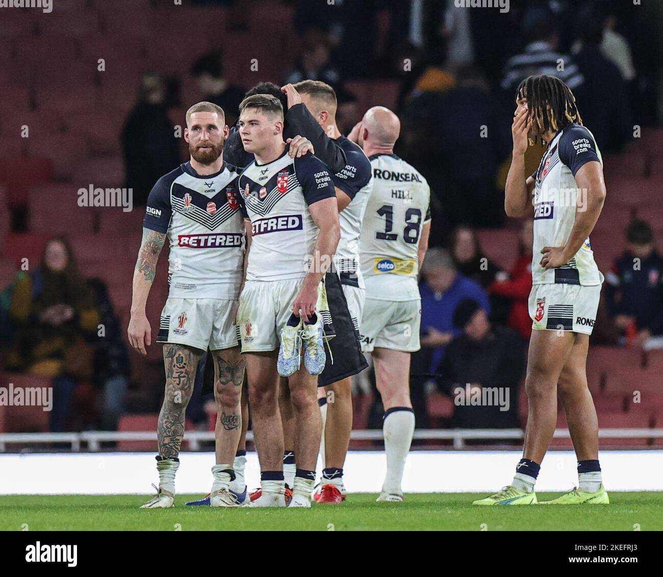 Sam Tomkins of England embraces Jack Welsby of England as England crash ...