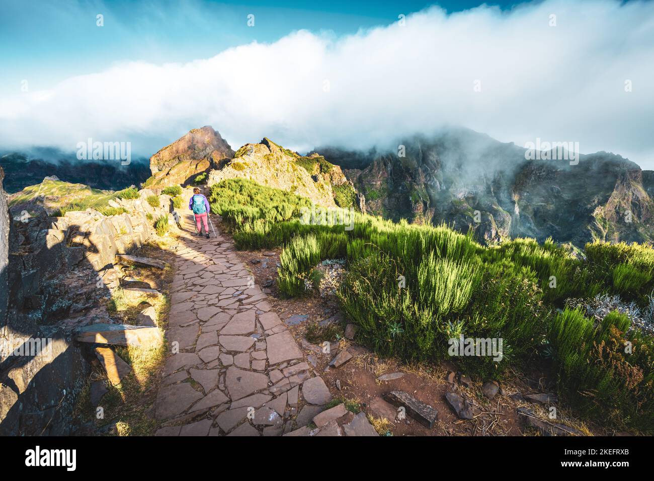Description: Woman hiking along scenic hike trail to Pico Ruivo in the ...