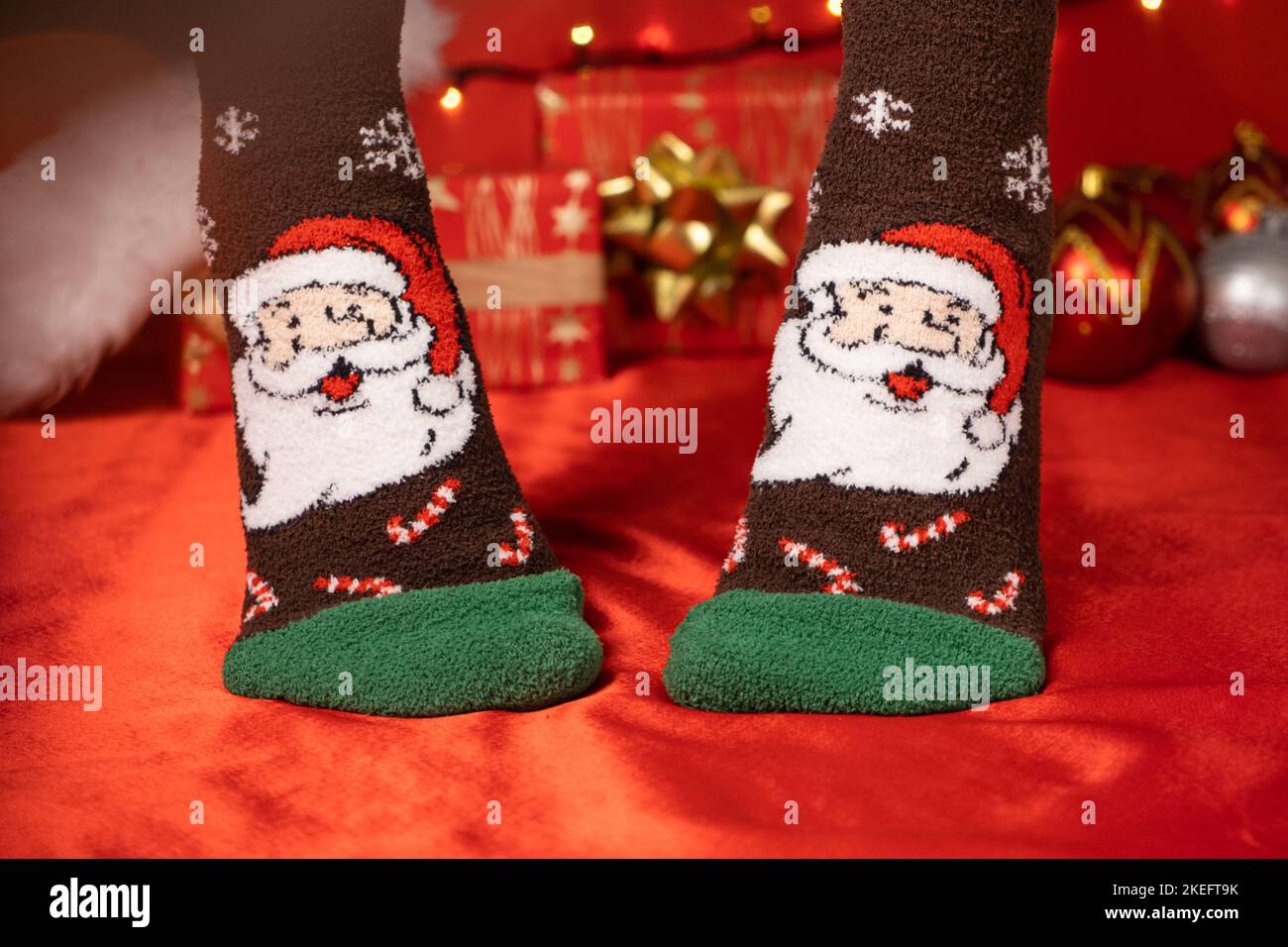 Women's feet in warm Christmas socks with Santa Claus close-up Stock ...