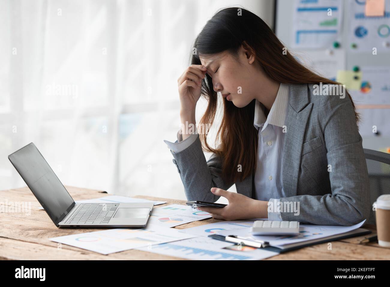 Stressed Asian business woman worry about marketing plan of this years ...