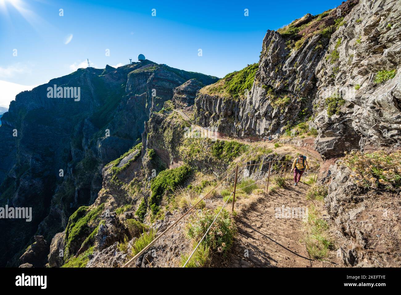Description: Woman hiking along scenic hike trail to Pico Ruivo in the ...