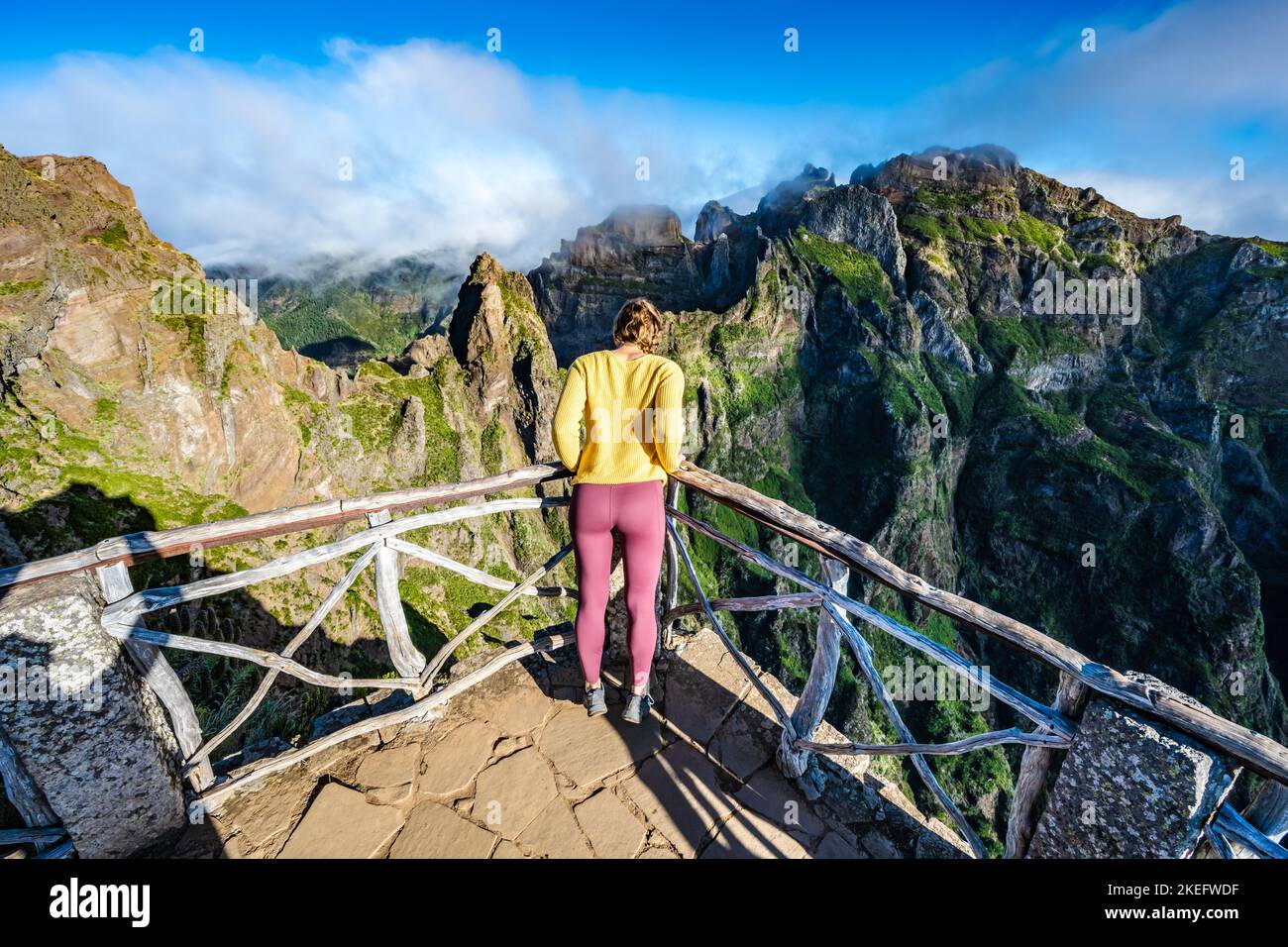 Description: Hiker enjoying the mountain scenery of Pico Ruivo from a ...