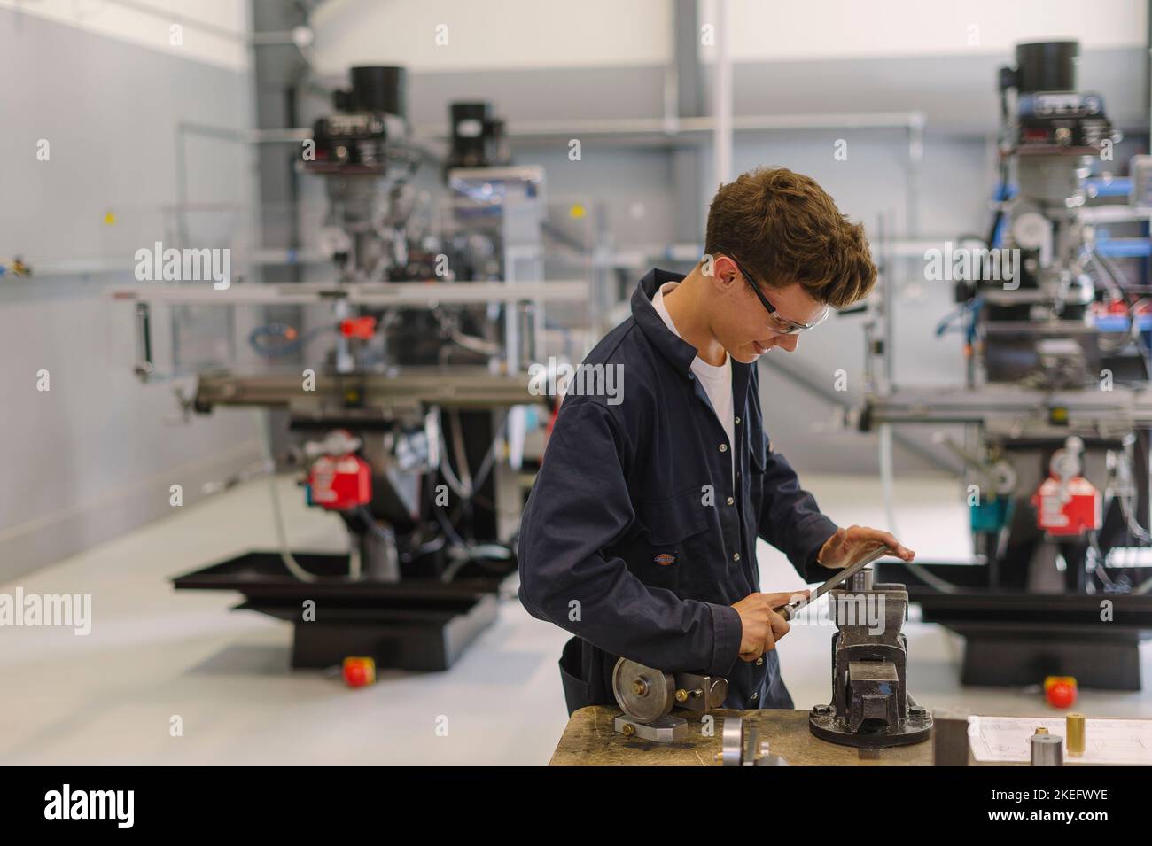 An Engineering student using tools in an engineering centre, college ...