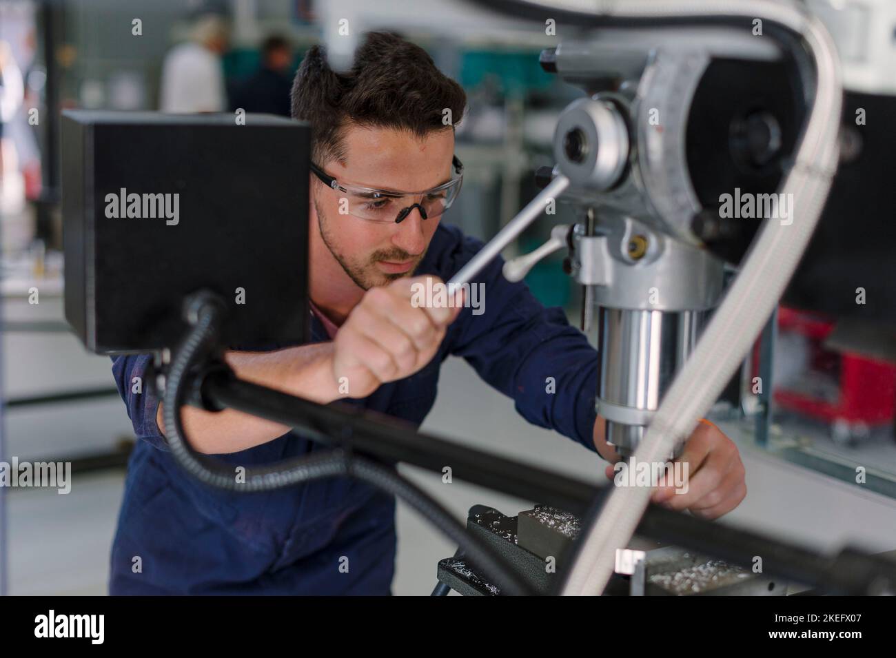 An Engineering student using tools in an engineering centre, college ...