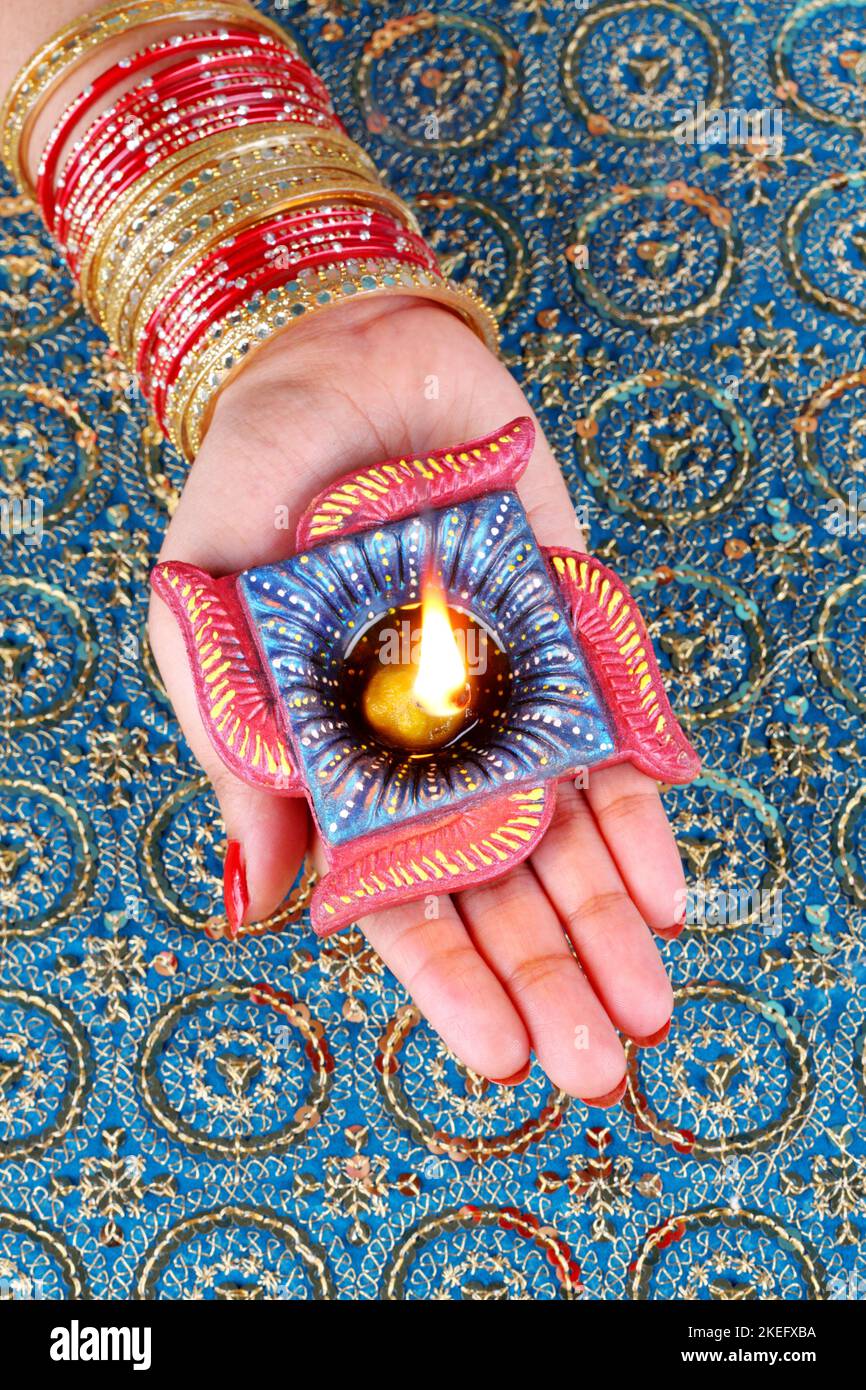 Diwali Celebration Diya on a Female Hand Stock Photo - Alamy