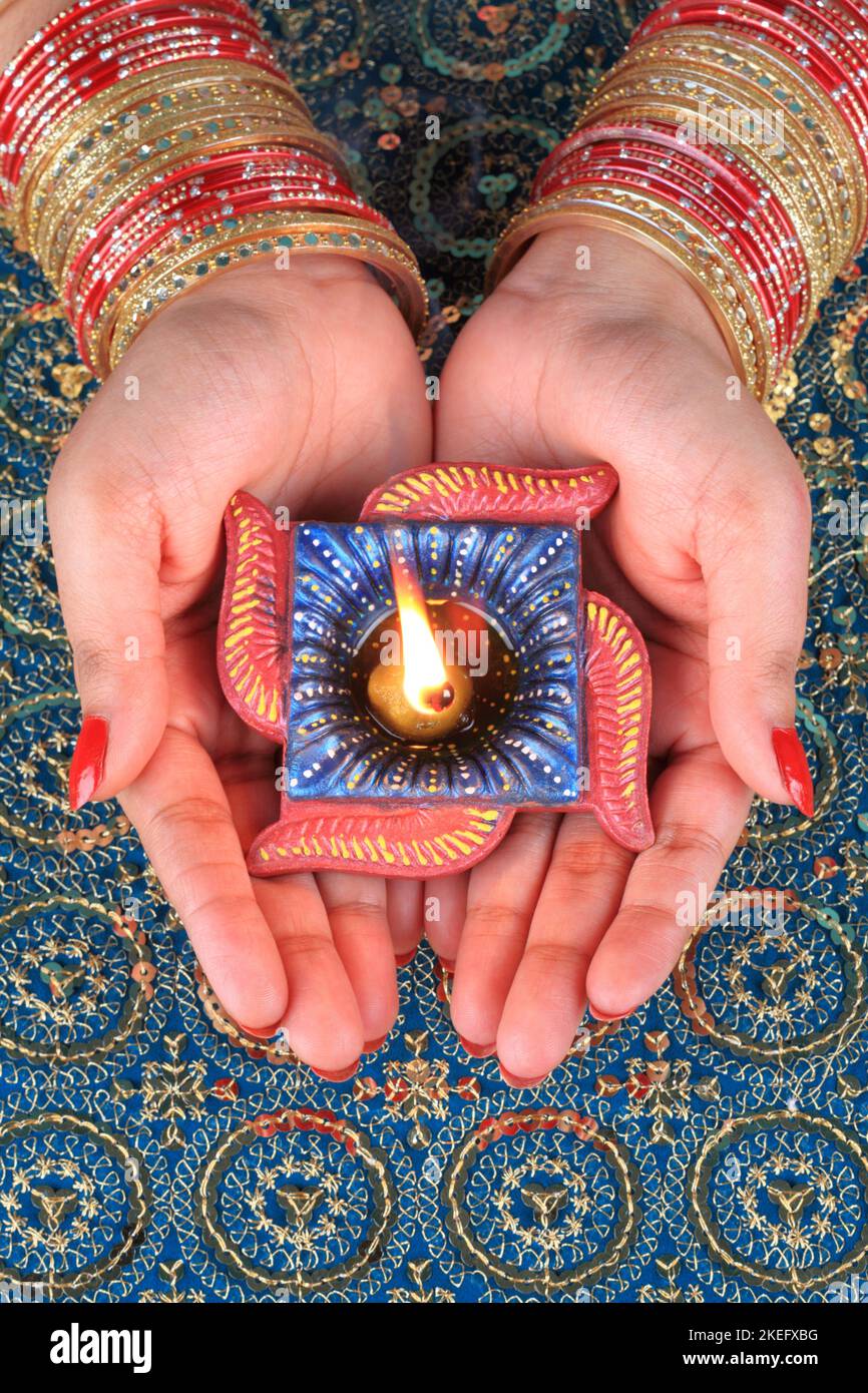 Diya in hand hi-res stock photography and images - Alamy