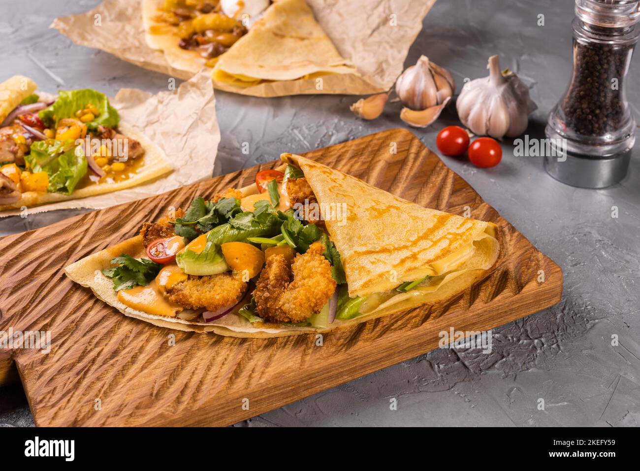 Pancake or crepe with fried shrimp tomatoes and vegetables and cheese ...