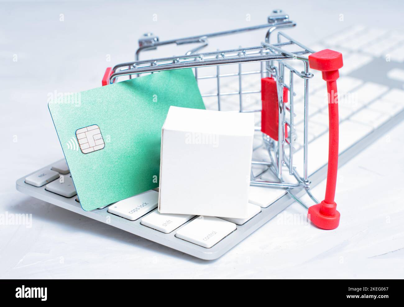 Miniature supermarket trolley with green credit card and tiny delivery ...