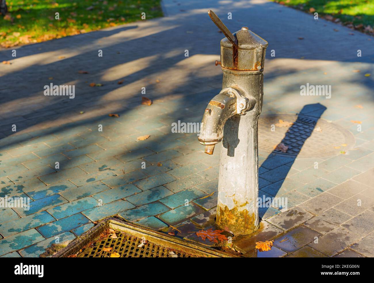 Front view of a weathered hand pump of the public drinking water point ...