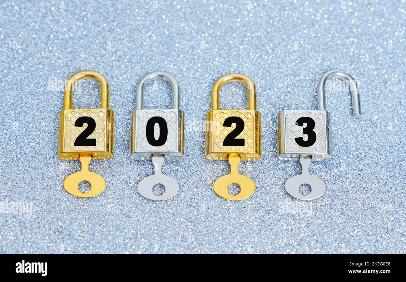 Unlocking the new year 2023: row of four labeled padlocks with master ...