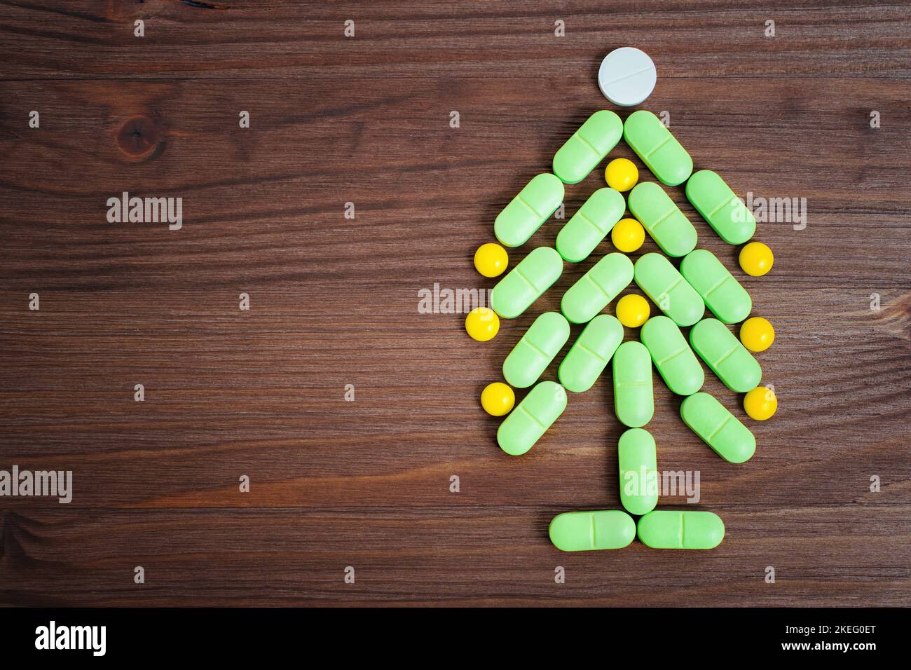 Decorated Christmas tree flat lay made from pills on a wooden ...