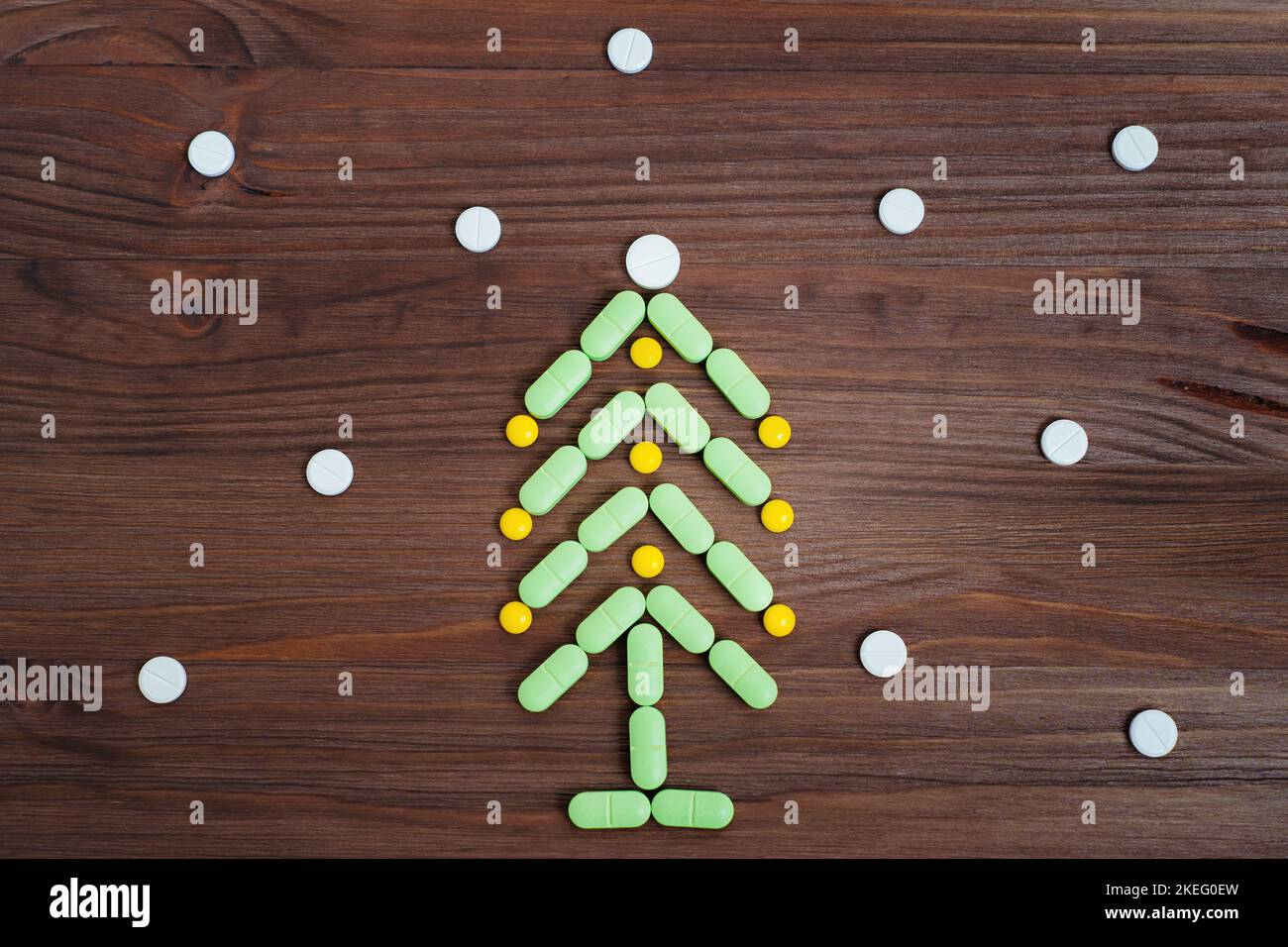 Decorated Christmas tree flat lay made from pills on a wooden ...