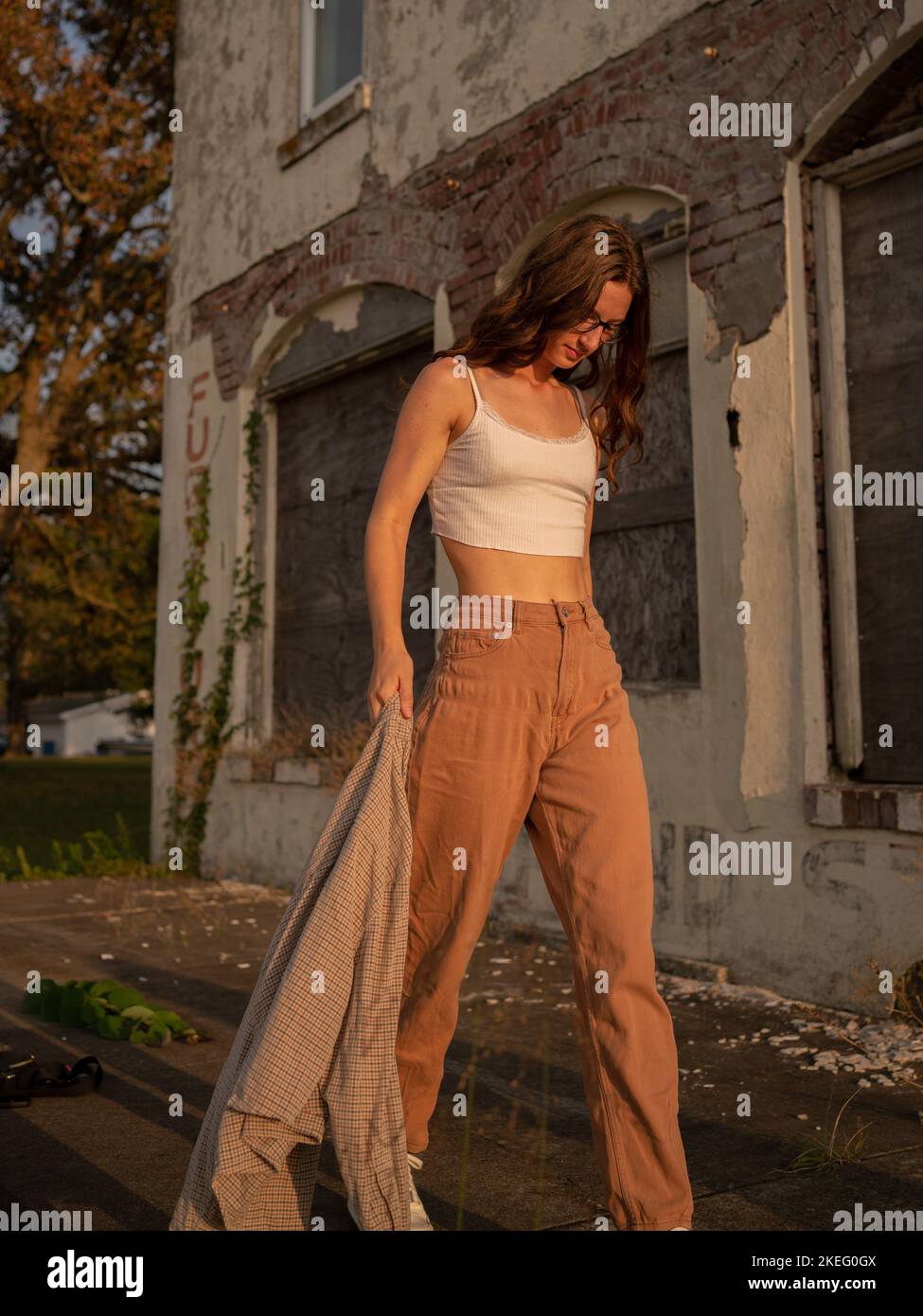 A vertical shot of a fashionable young Caucasian female walking in a ...