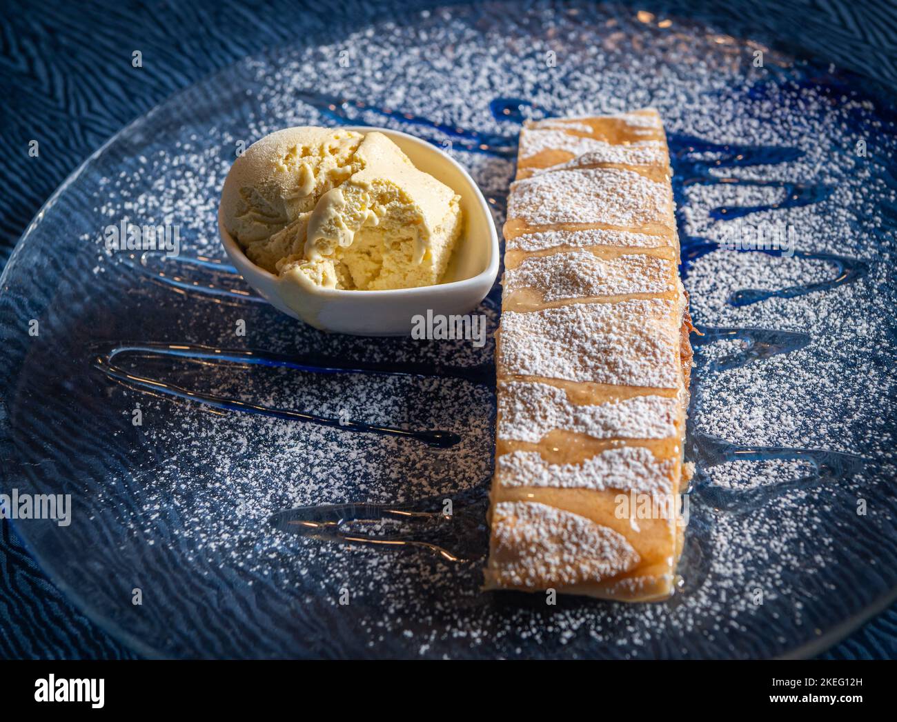 strudel and vanilla ice cream on the plate and powdered sugar.Apple ...