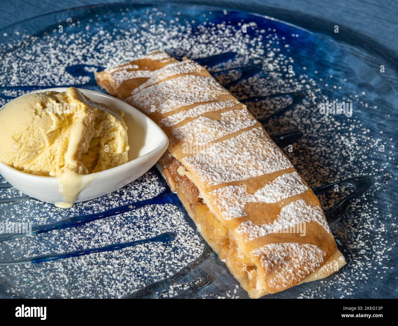 strudel and vanilla ice cream on the plate and powdered sugar.Apple ...