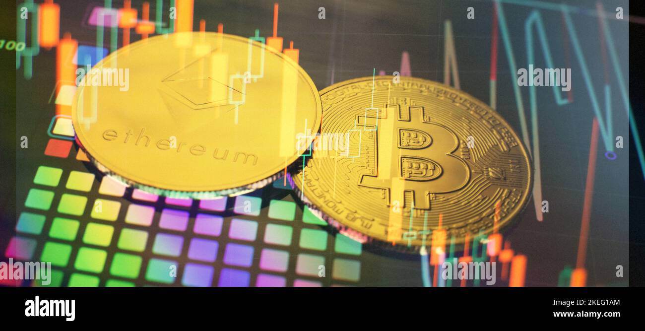 Gold bitcoins on a stack of coins with chart of growing and falling ...