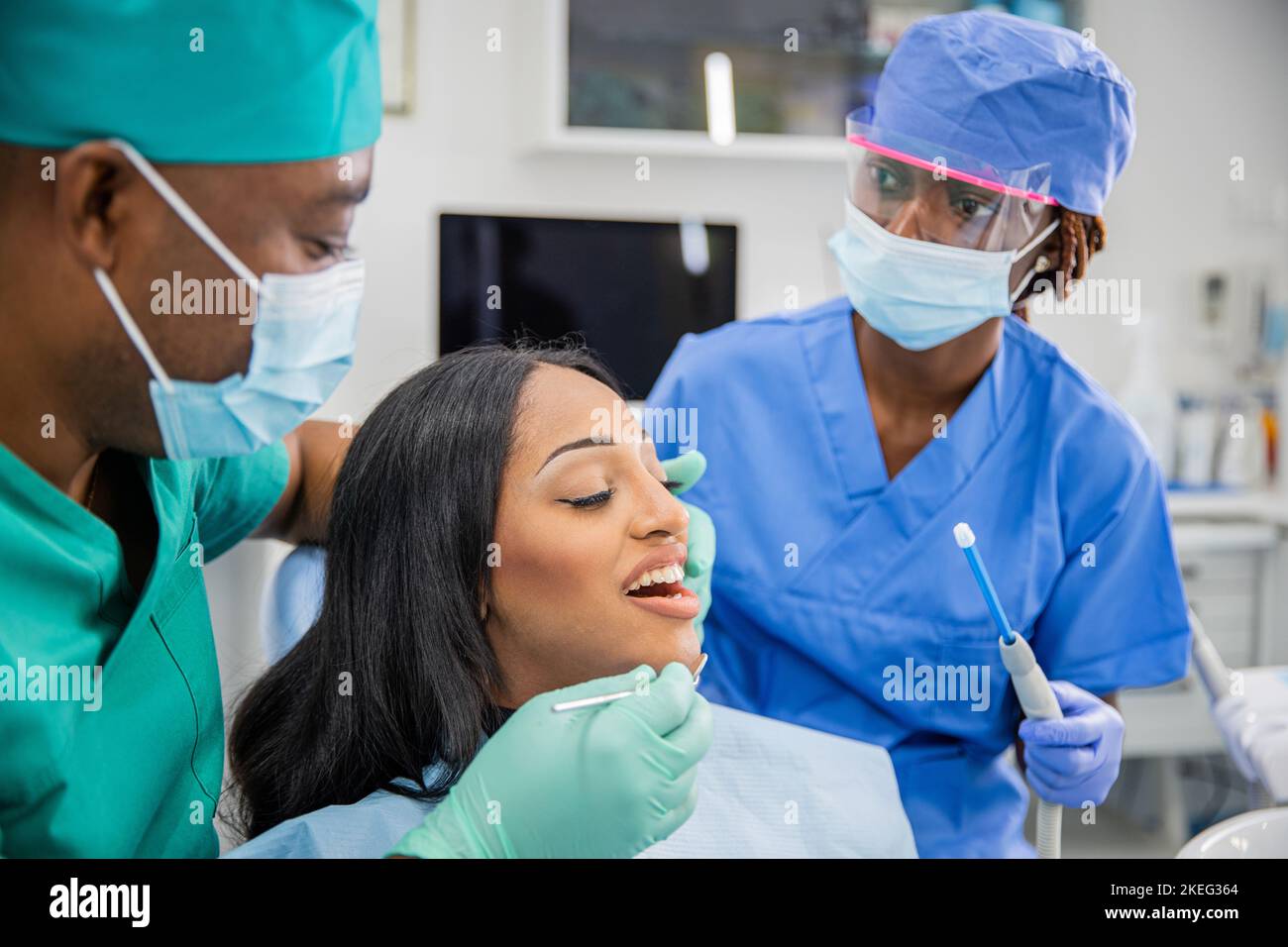 Girl with open mouth during a dental visit, dentist and assistant at ...