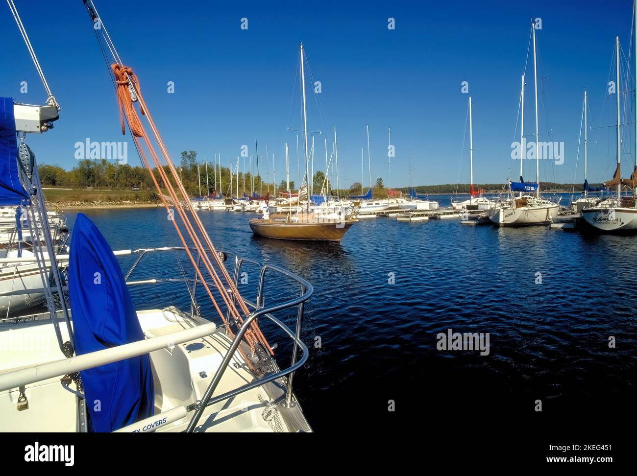 A sailboat motors out of a marina on Stockton Lake in the Missouri ...