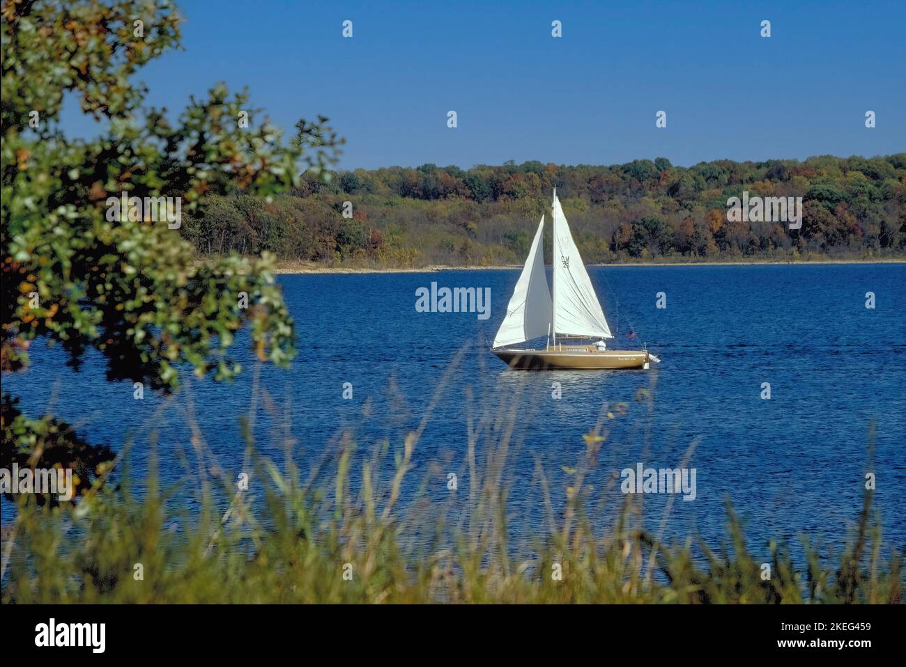 A sailboat glides over the blue waters of Stockton Lake in the Missouri ...