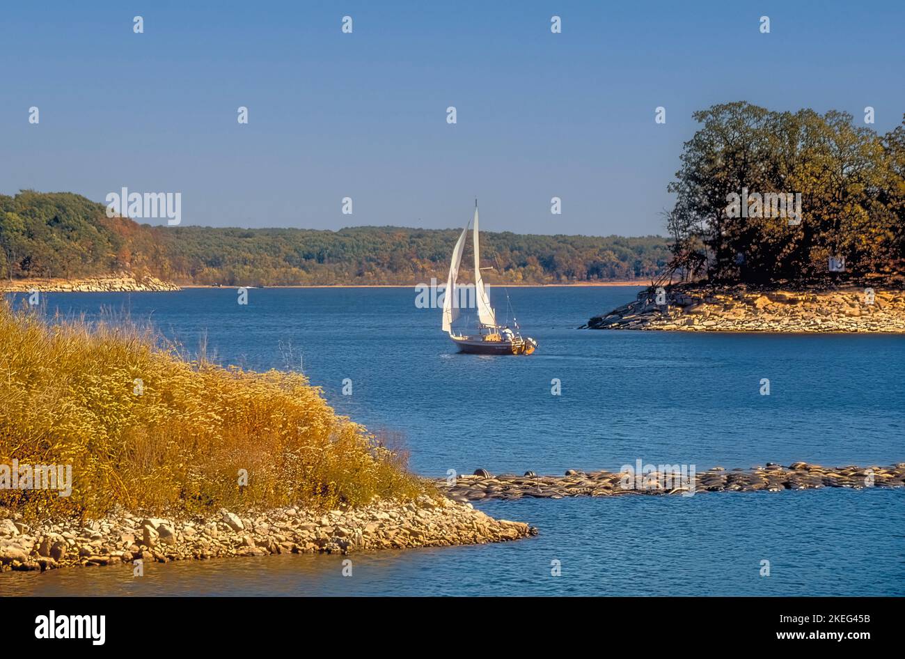 A sailboat glides over the blue waters of Stockton Lake in the Missouri ...