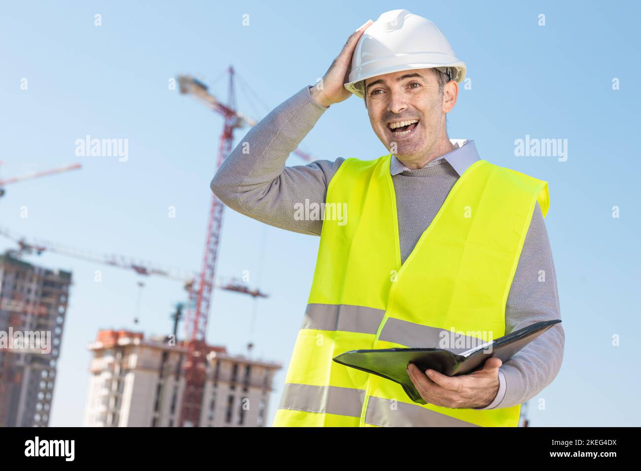 Professional builder standing with a notebook in front of the ...