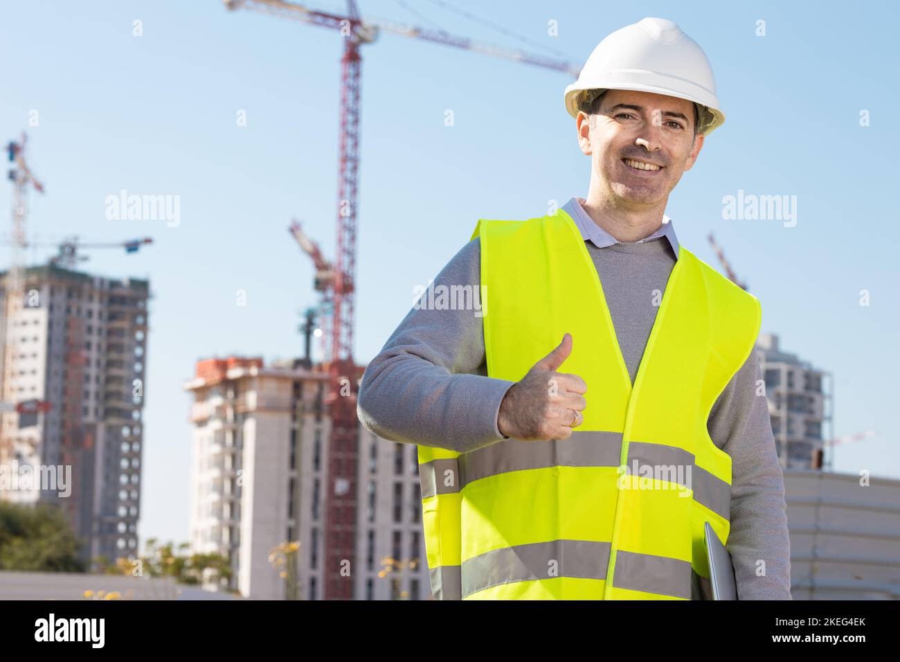 Professional builder standing with a notebook in front of the ...