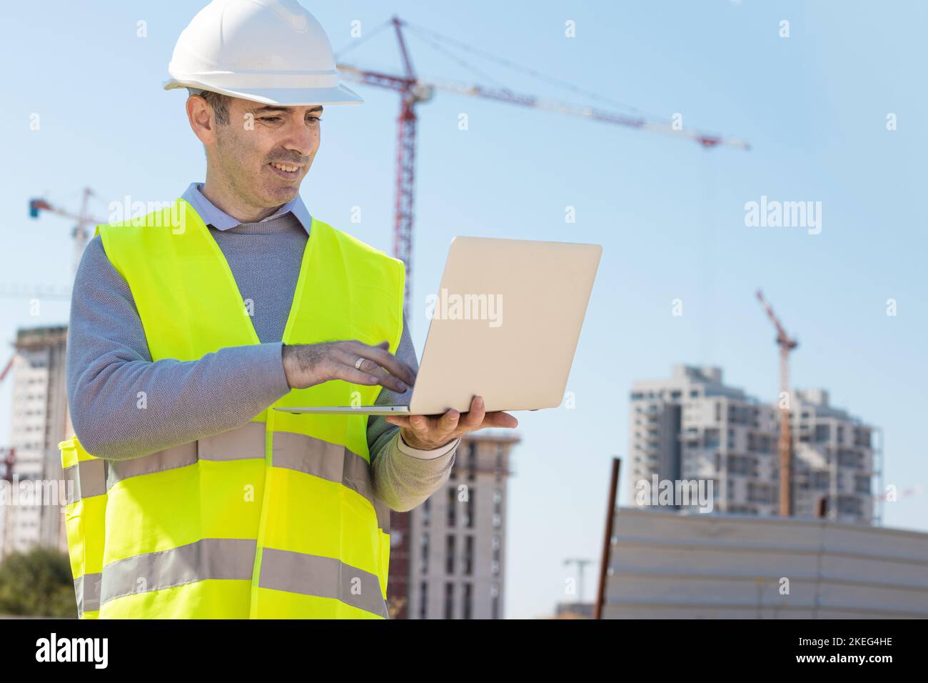 Professional builder standing with notebook in front of the ...