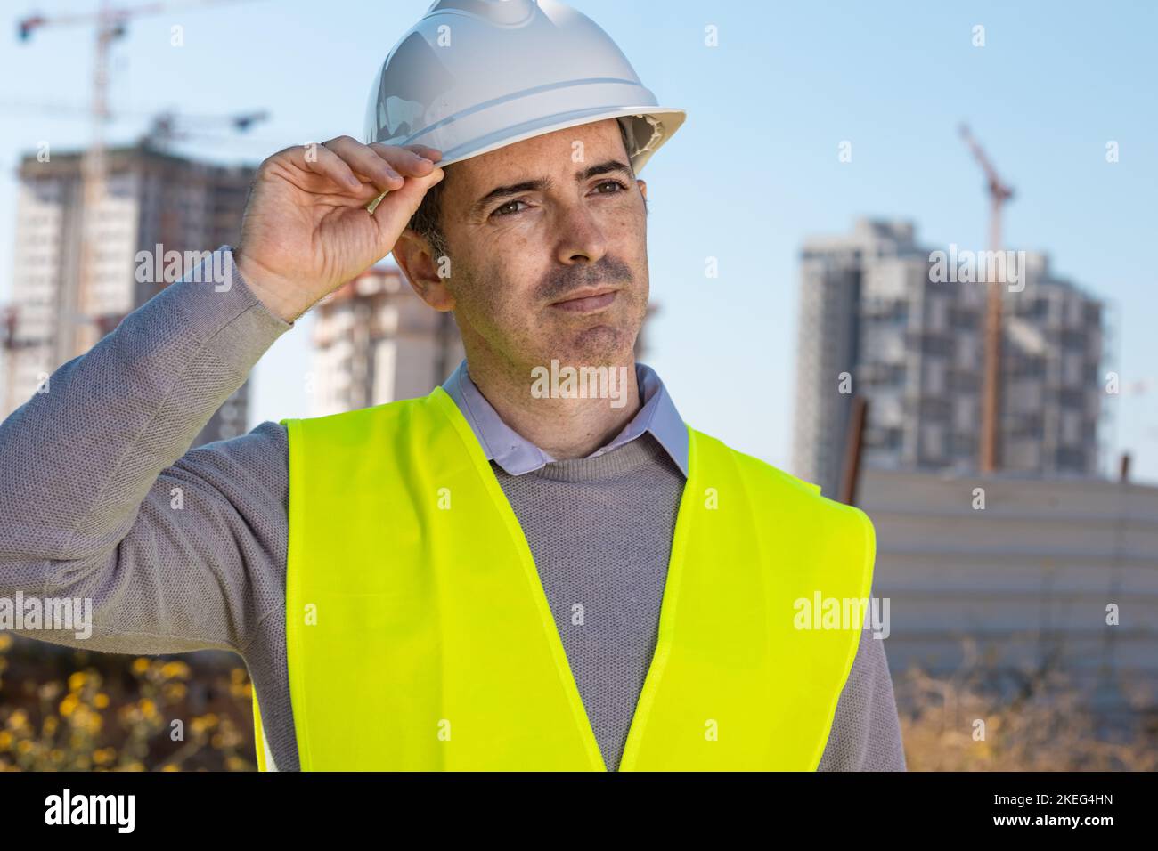 Professional builder standing with notebook in front of the ...