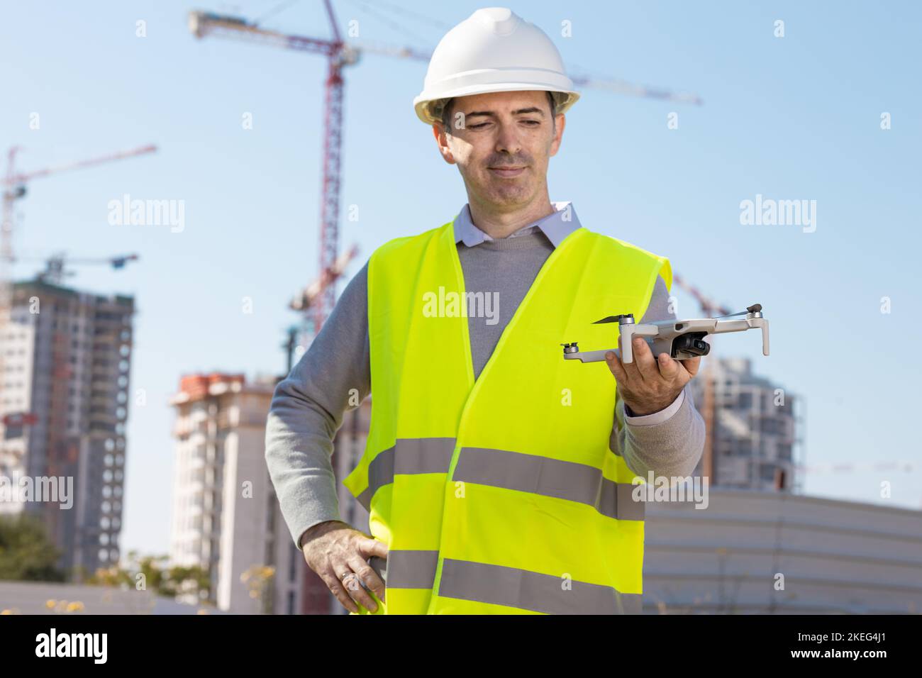 Man launches a quadcopter. An engineer flies a drone next to a ...