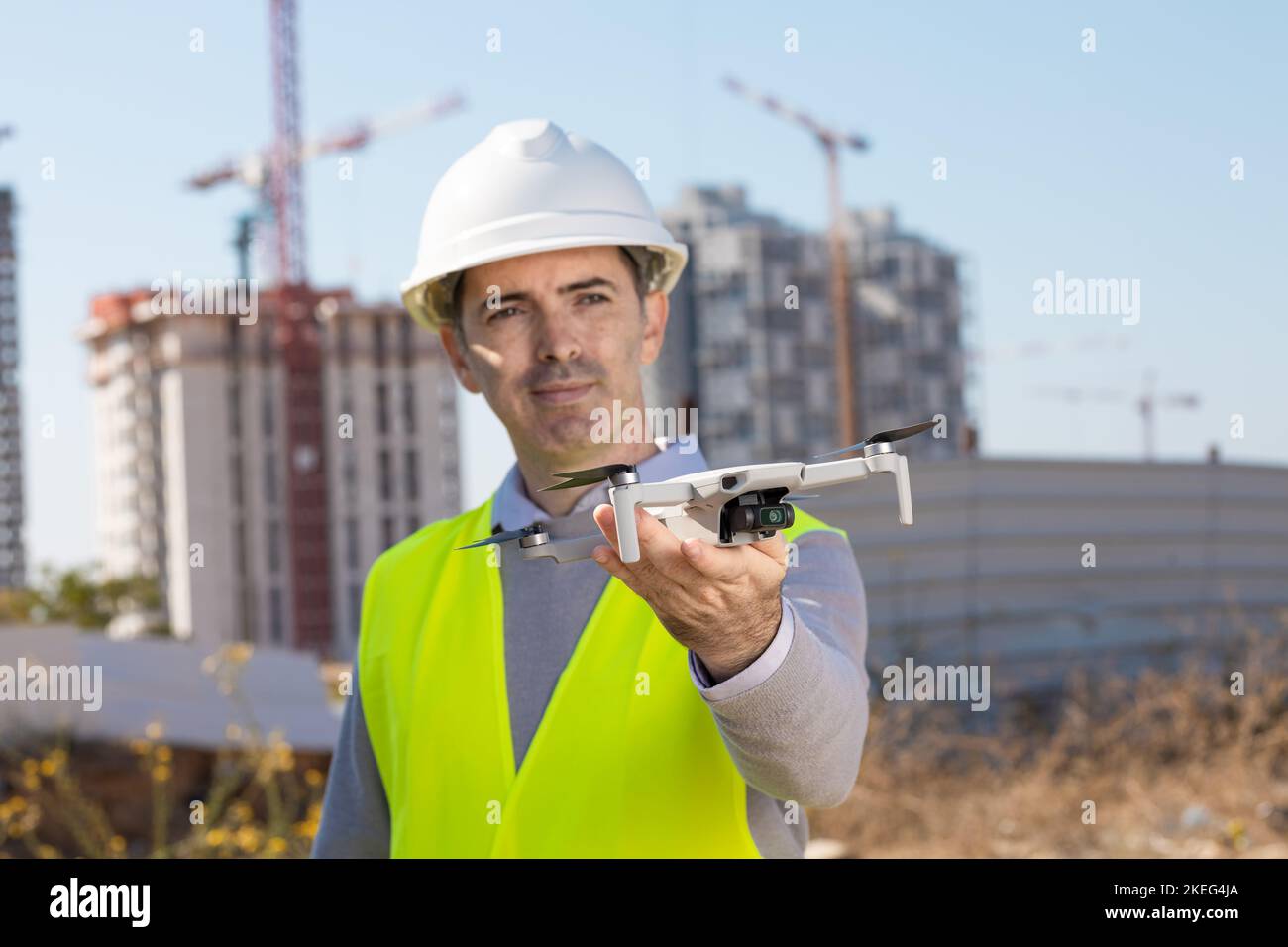 Man launches a quadcopter. An engineer flies a drone next to a ...