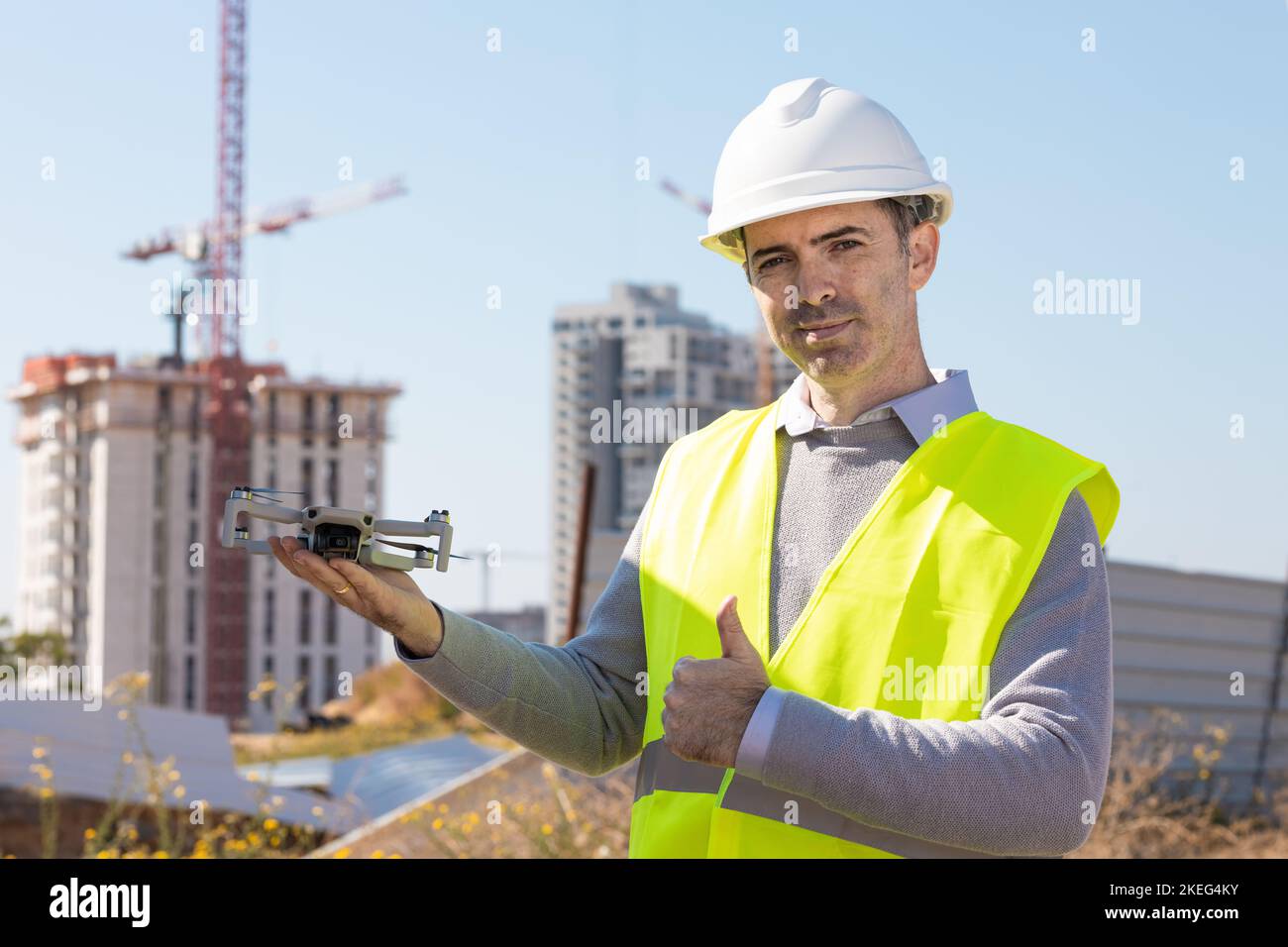 Man launches a quadcopter. An engineer flies a drone next to a ...