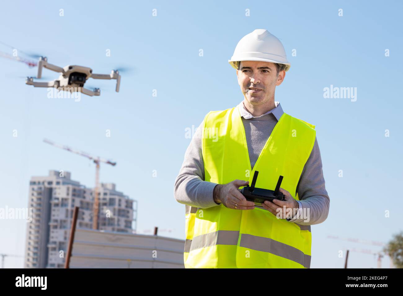 Man launches a quadcopter. An engineer flies a drone next to a ...