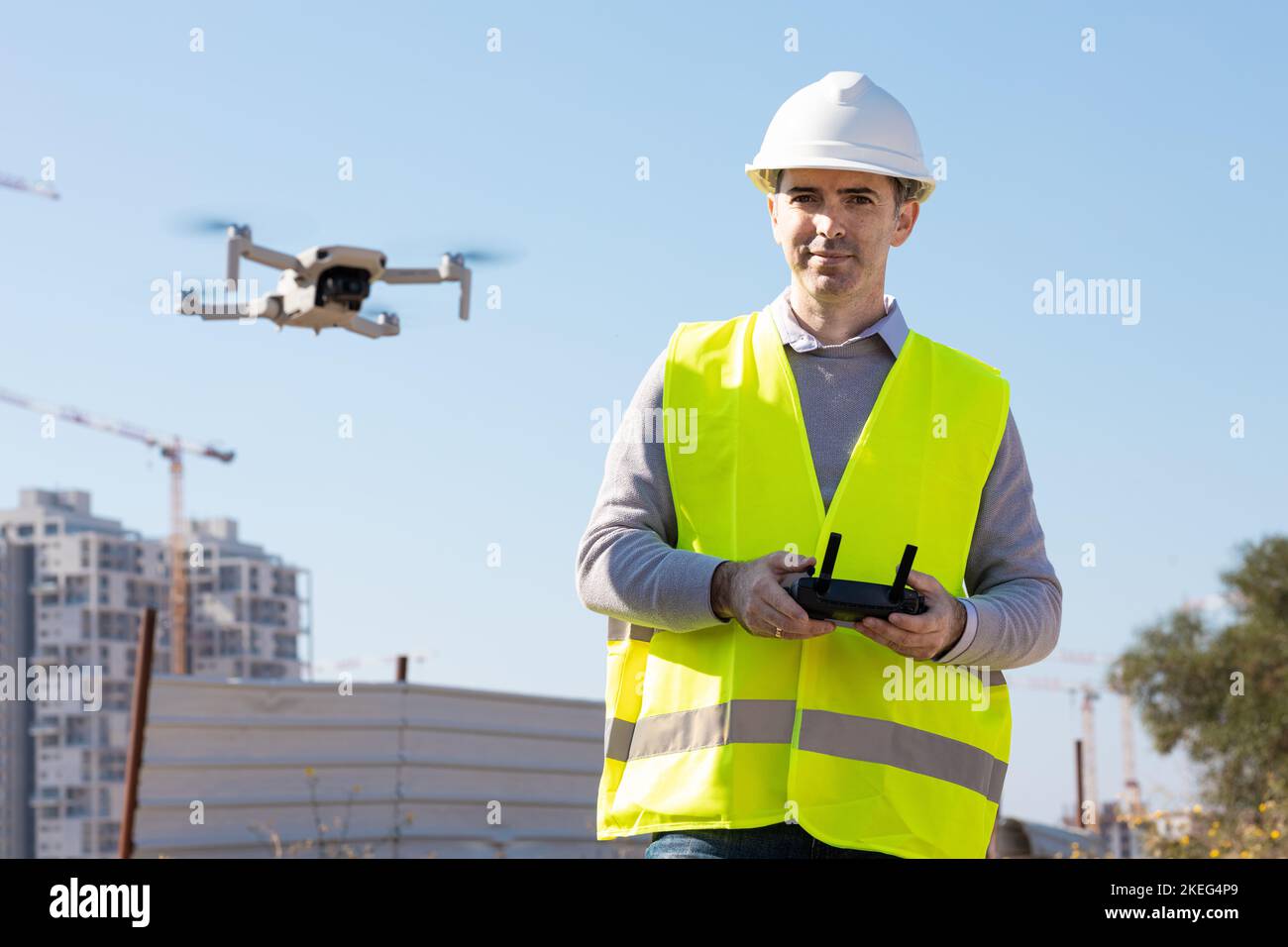 Man launches a quadcopter. An engineer flies a drone next to a ...