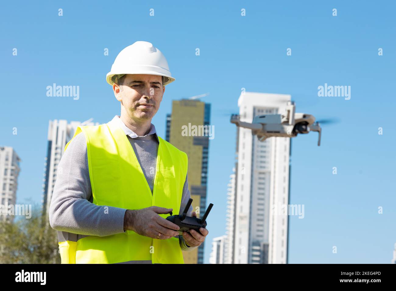 Man launches a quadcopter. An engineer flies a drone next to a ...