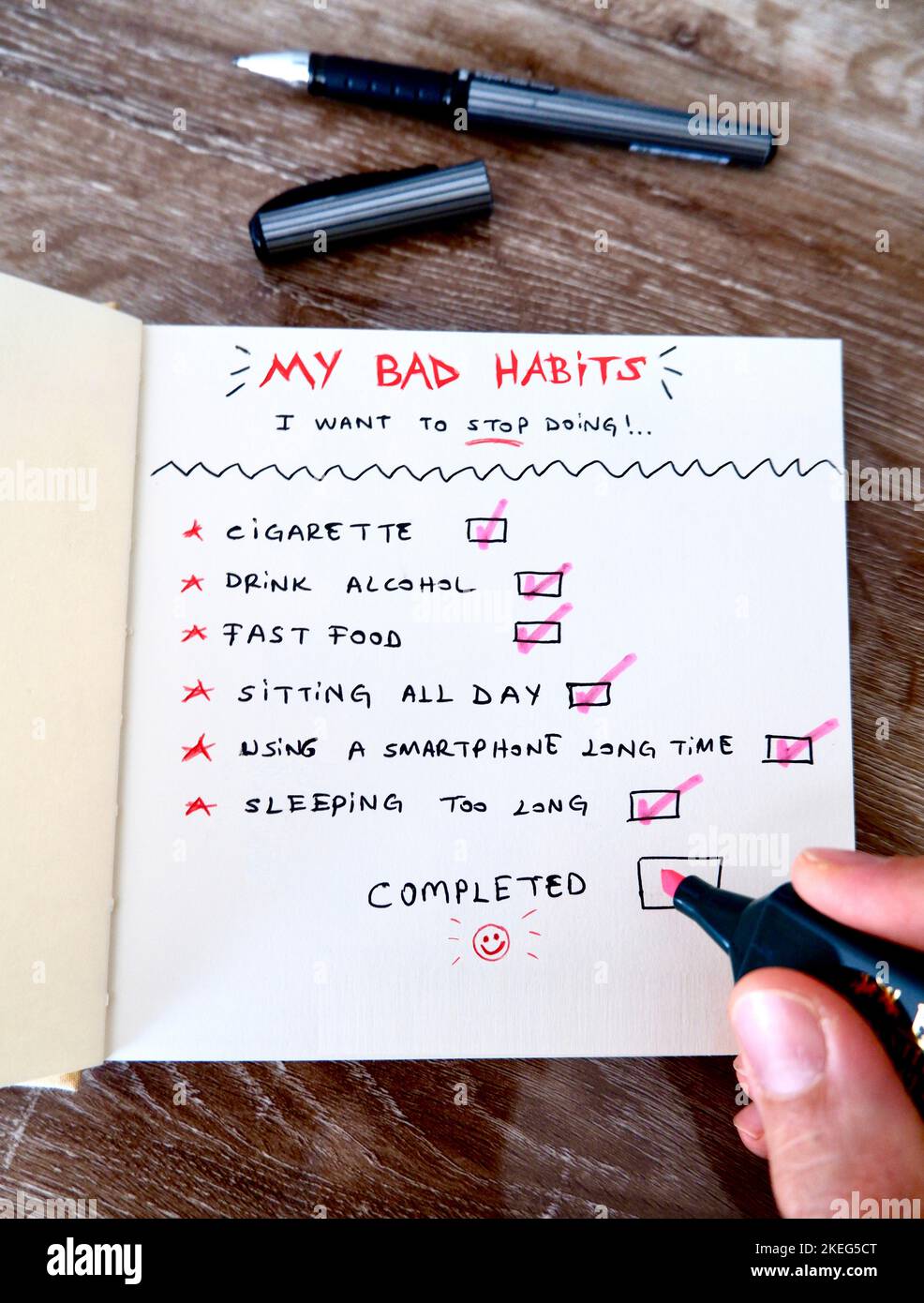 A vertical shot of a bad habits checklist written on a paper Stock ...