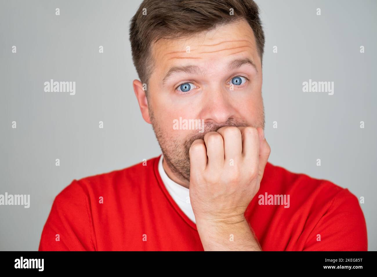Anxious stressed young man looking at camera. He has paranoia or mental ...