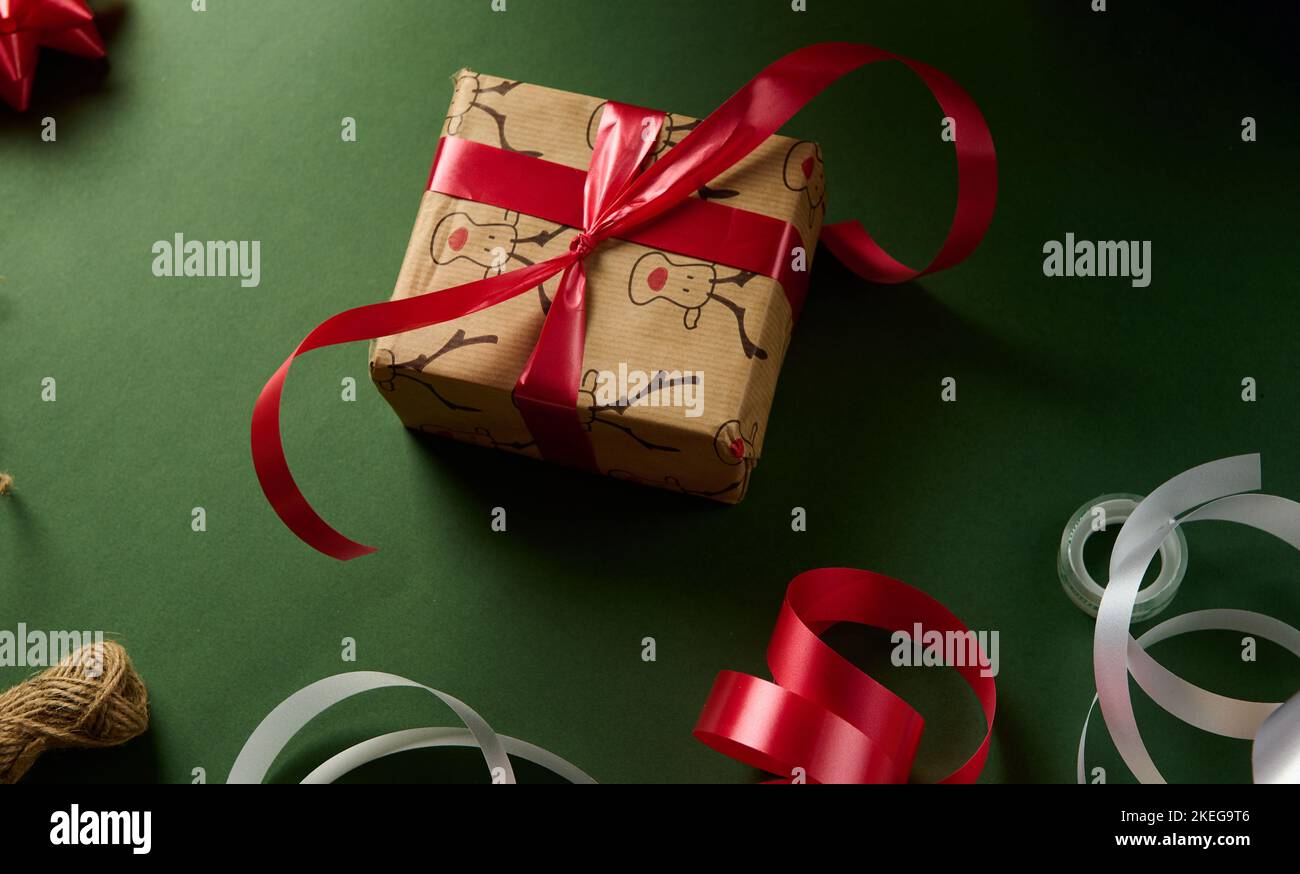 Top view Christmas gift box, wrapped in decorative wrapping paper, tied ...