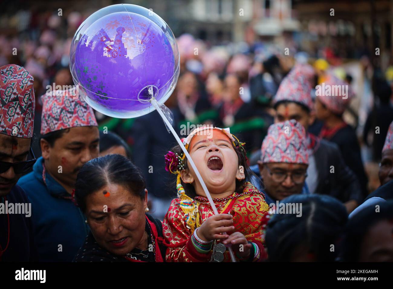 Nepal. 12th Nov, 2022. A kid reacts yawns as she holds a ballon during ...