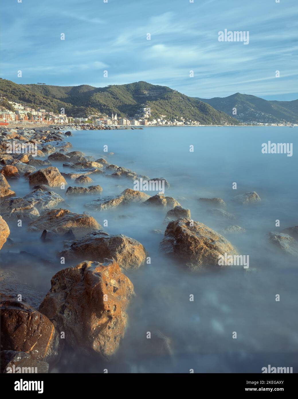 The rocky seashore by the small town on the Italian Riviera on a summer ...