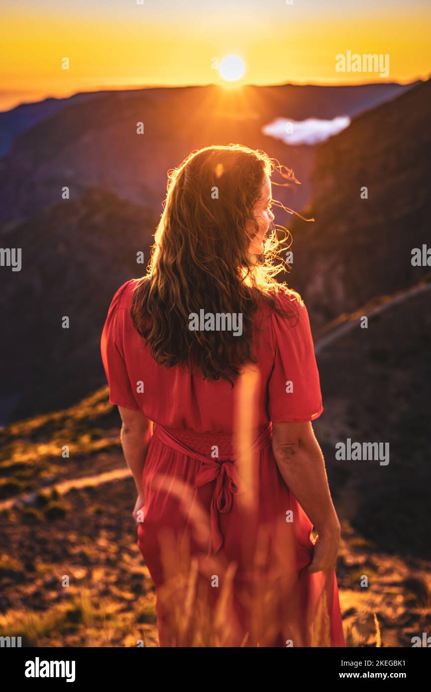 Description: Beautiful brown haired woman in red dress smiling in the ...