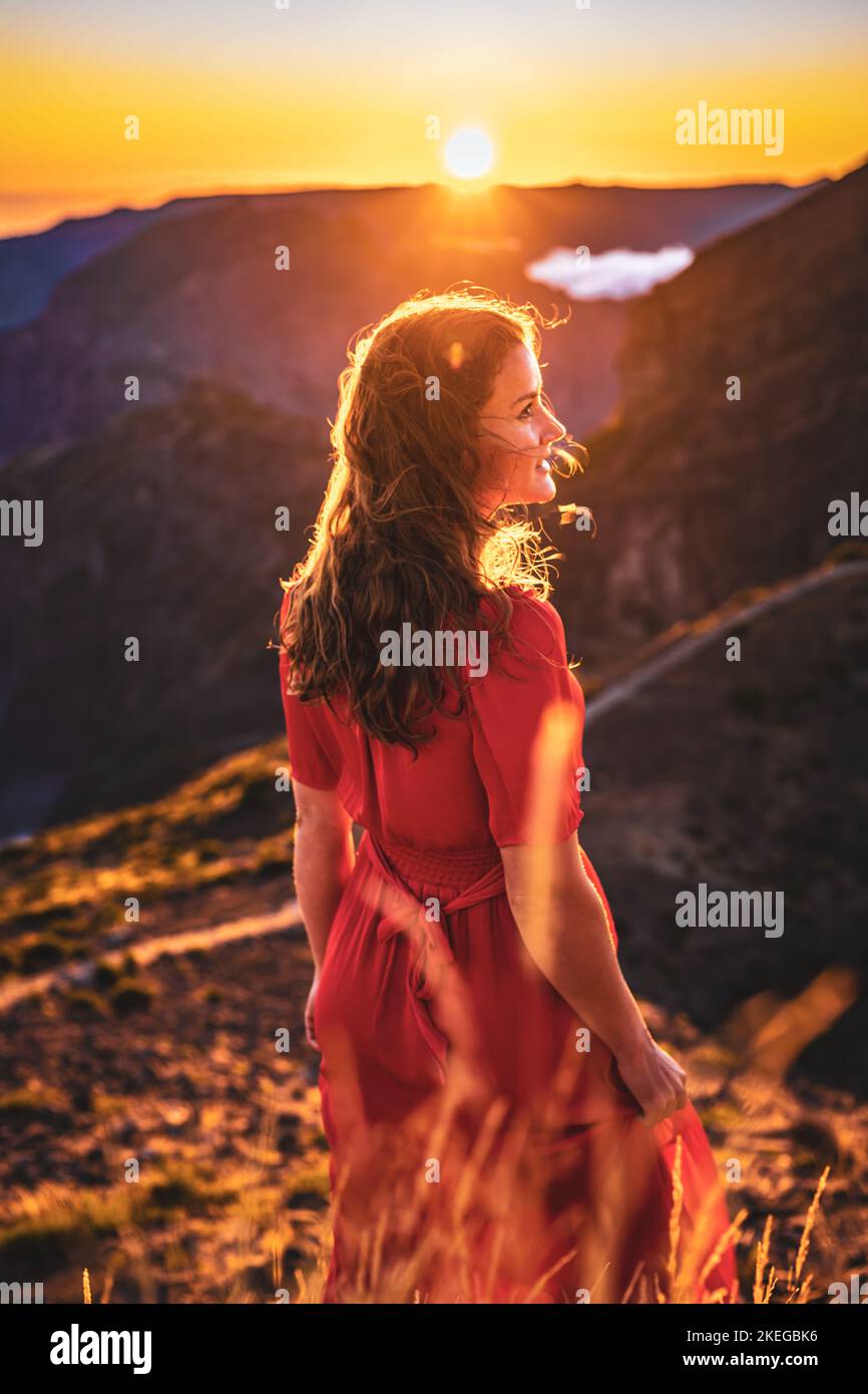 Description: Beautiful brown haired woman in red dress smiling in the ...