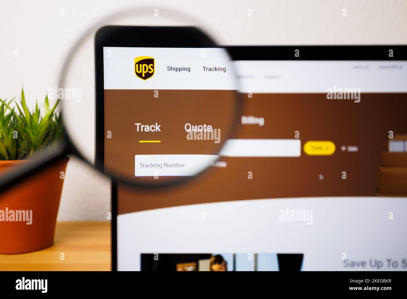 A logo of UPS on a laptop screen under a magnifying glass Stock Photo ...